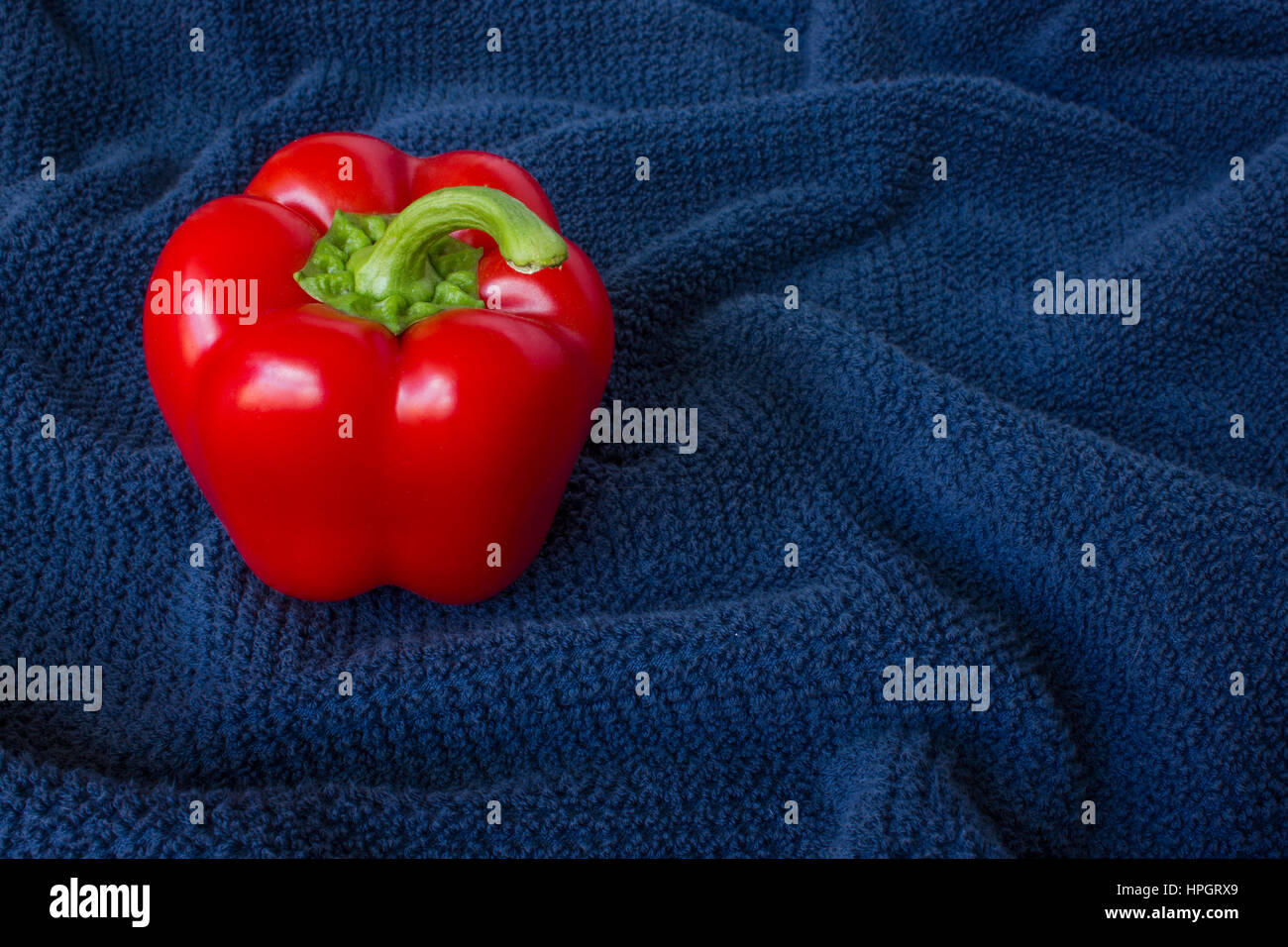 Colorfull picture of red pepper on a blue background Stock Photo - Alamy
