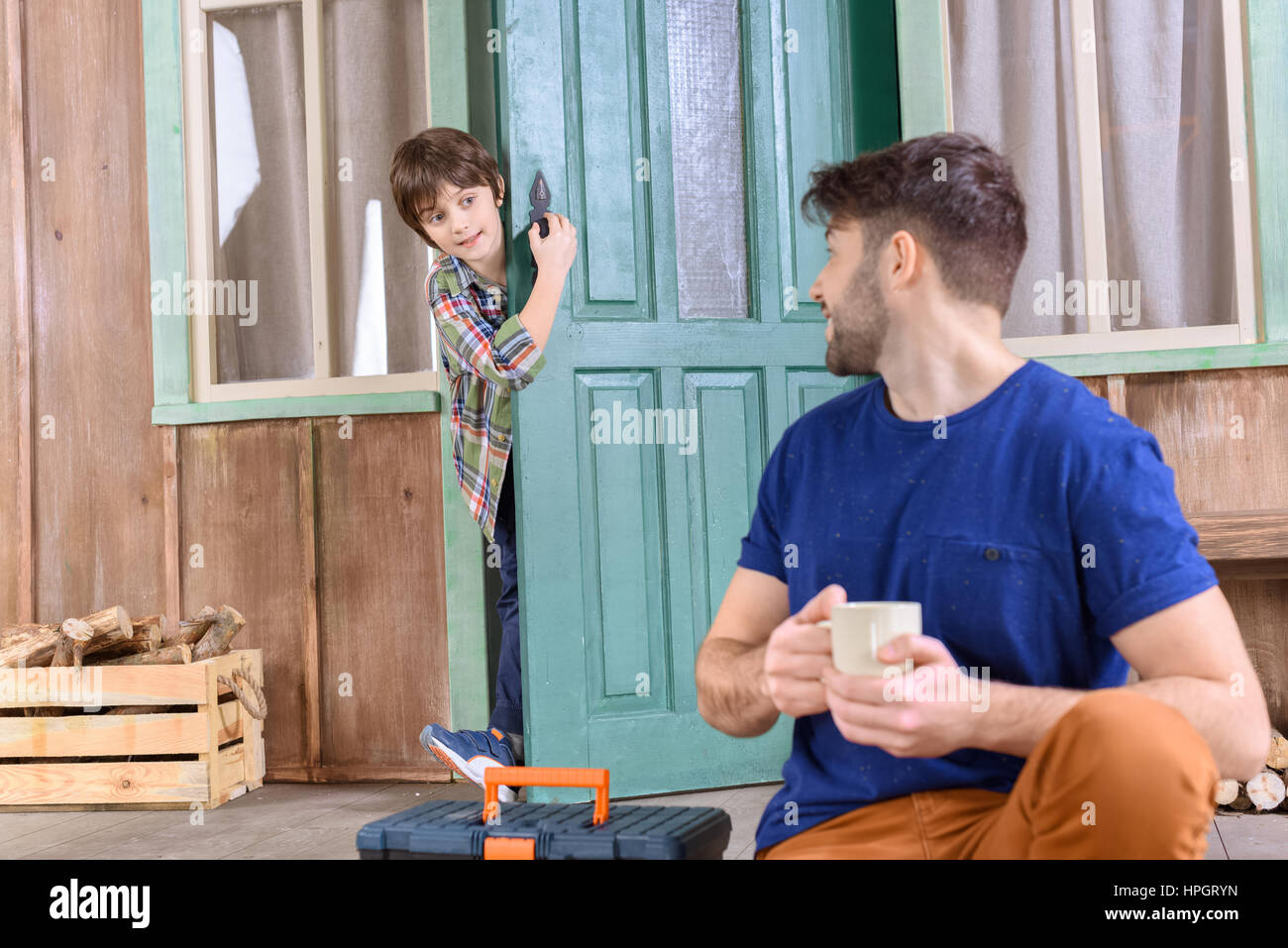 Boy sitting on front porch hi-res stock photography and images - Alamy