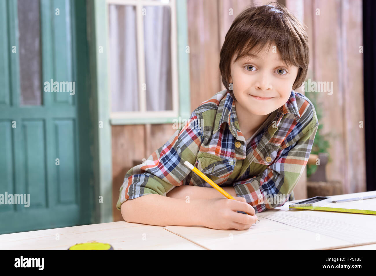 smiling boy with pencil in hands looking to camera Stock Photo - Alamy