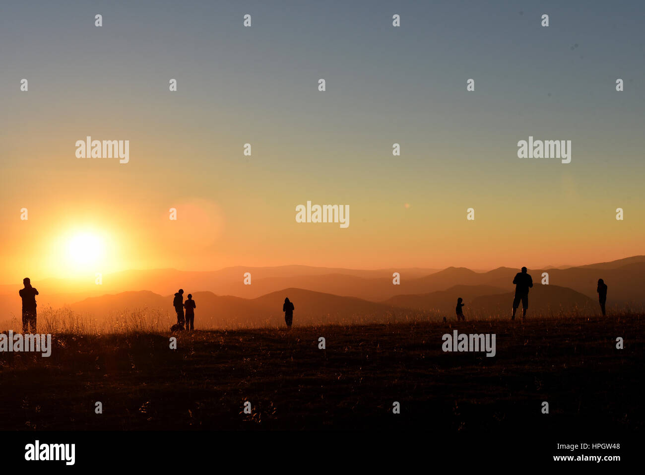 People relaxing and enjoying sunset in the mountains Stock Photo - Alamy
