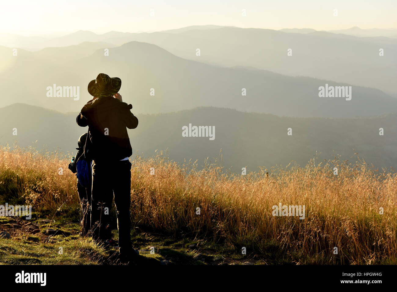 People relaxing and enjoying sunset in the mountains Stock Photo - Alamy