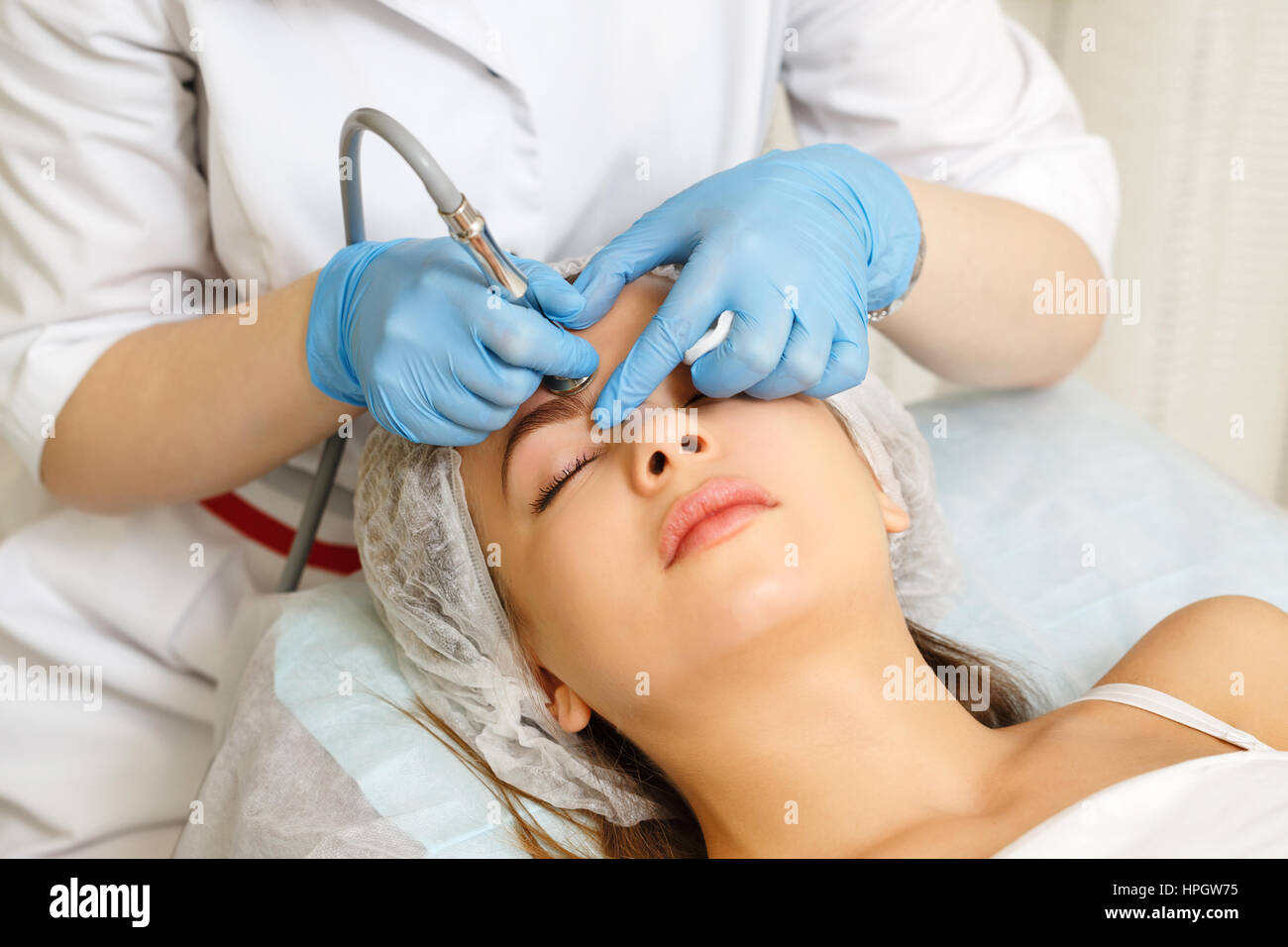 Dermabrasion girl's forehead. Instrumental cosmetology. Spa. Facial ...