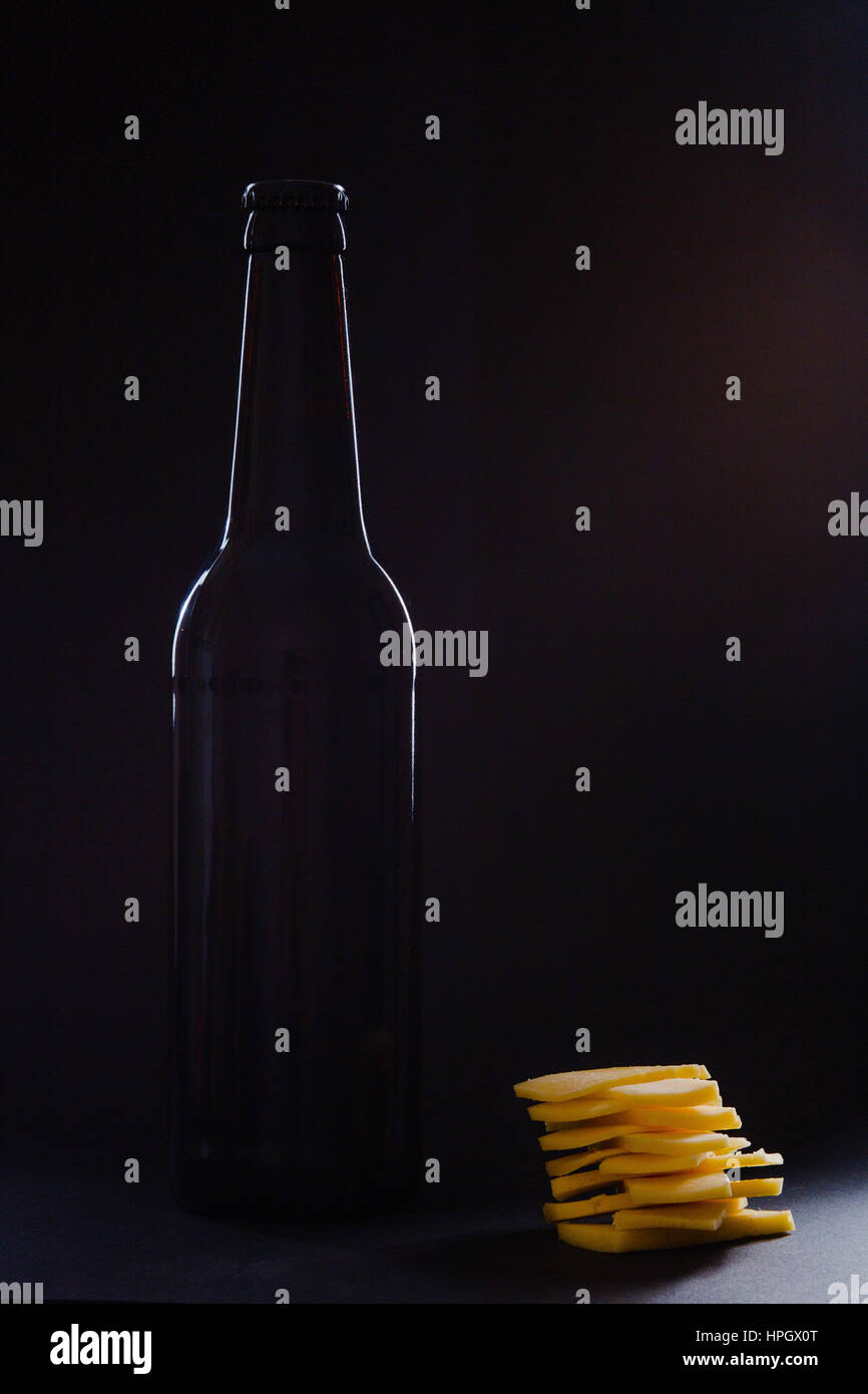 Contour of beer bottle and cheese on the black background Stock Photo ...
