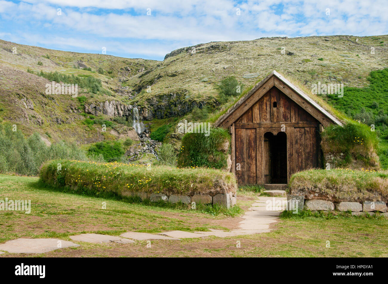 Icelandic Viking Longhouse with Waterfall in Background ...