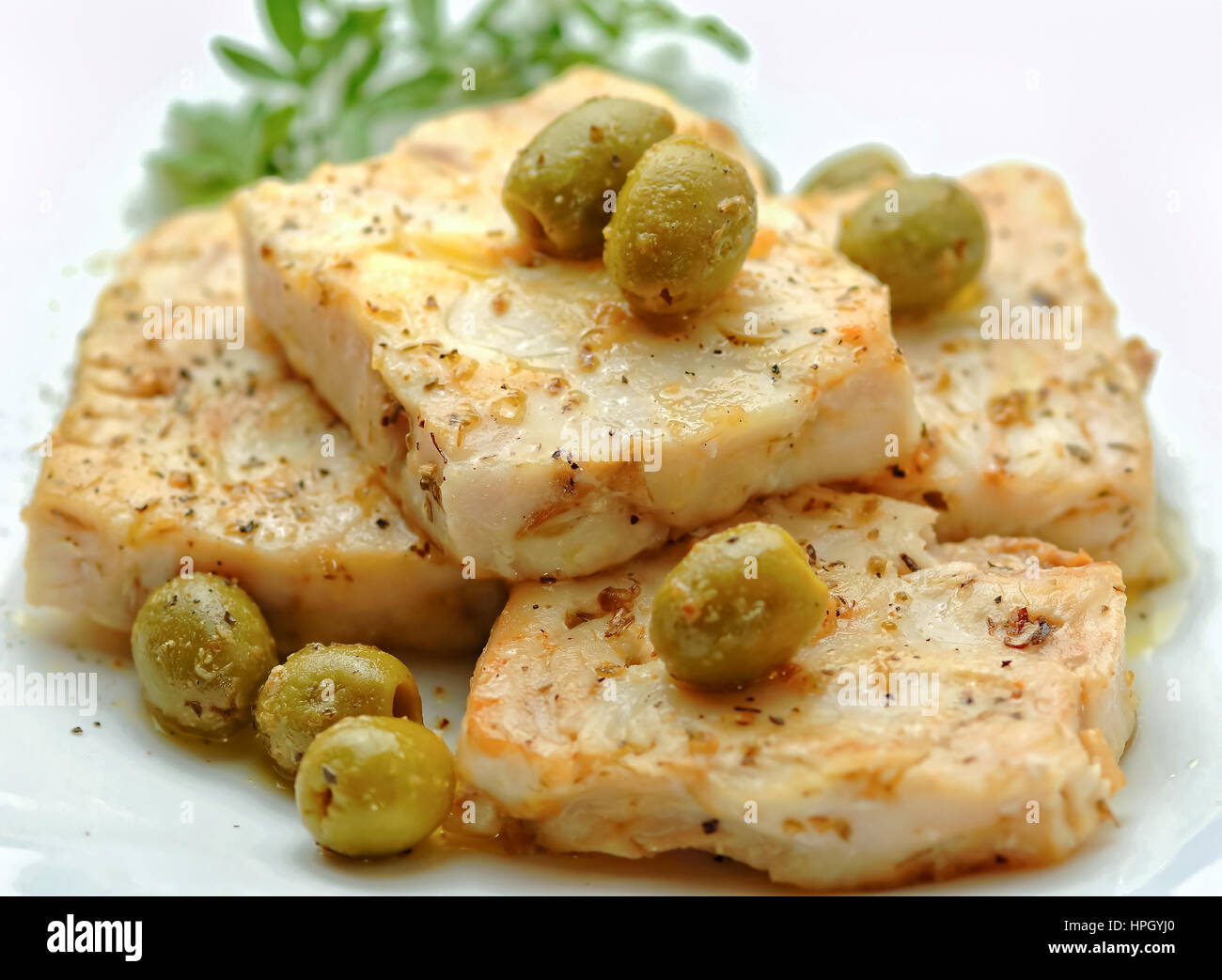 Cod fish with green olives Stock Photo - Alamy