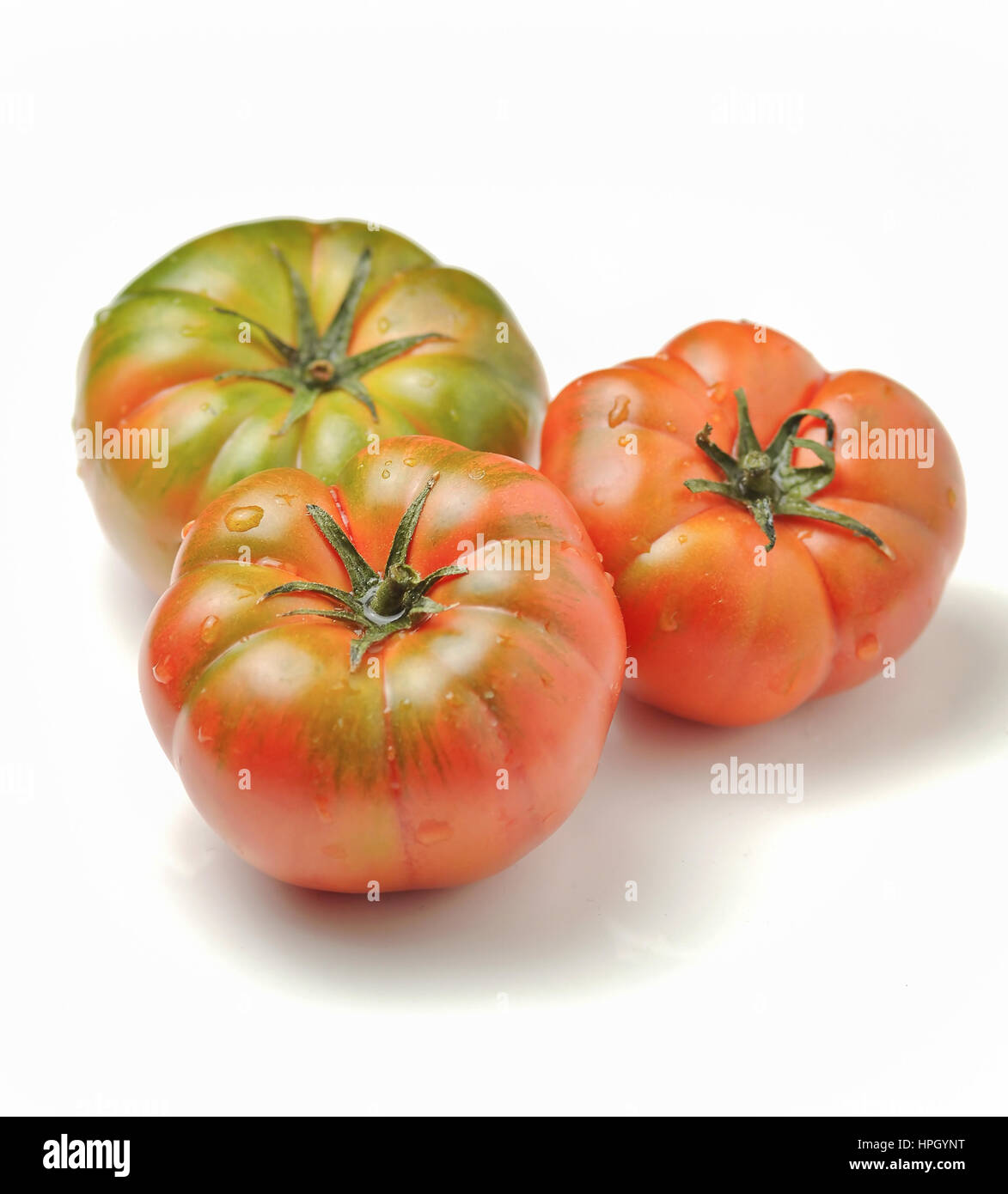 Ripe red heirloom tomatoes isolated Stock Photo - Alamy
