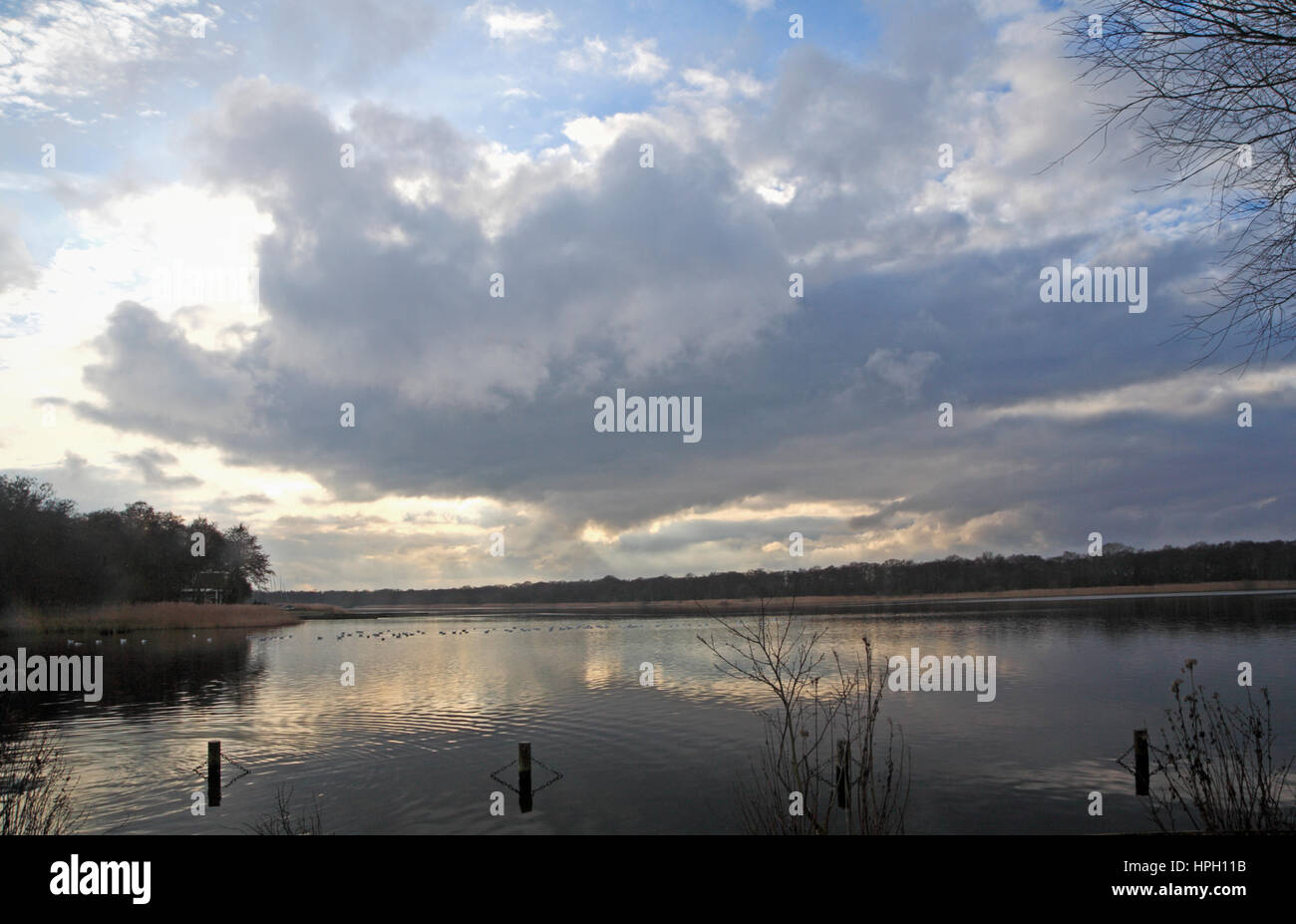 A view of Rollesby Broad with clearing skies on the Norfolk Broads at ...