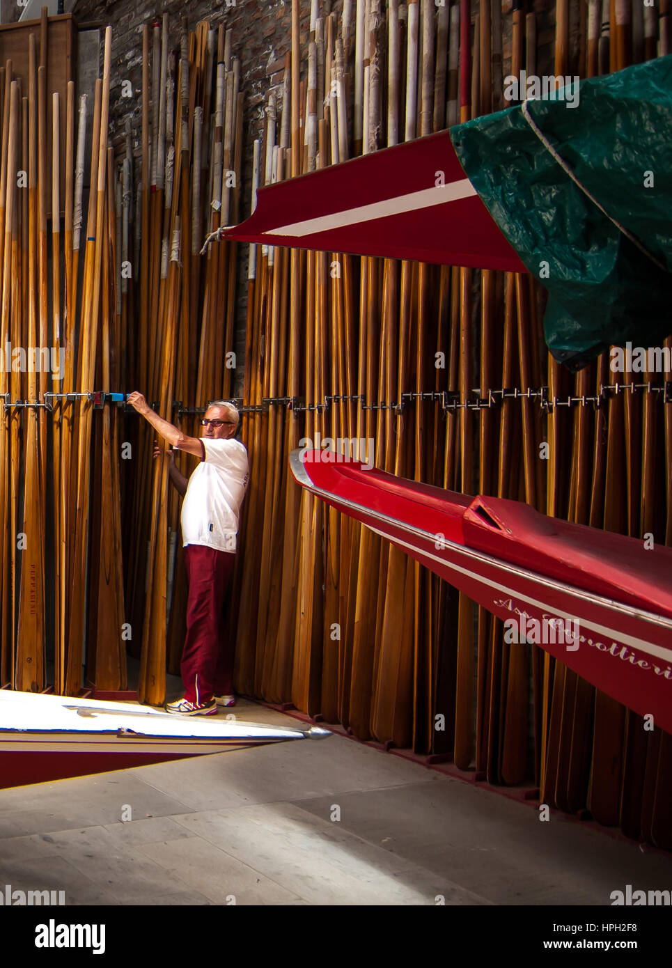 VENICE, ITALY: A volunteer puts the oars in the warehouse of a remiera ...
