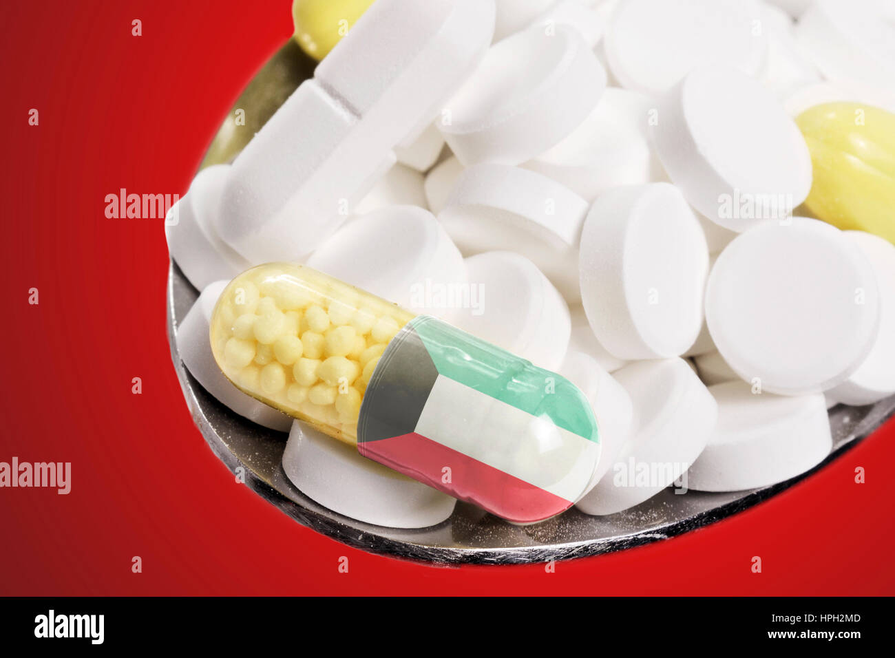 The national flag of Kuwait on a capsule and pills on a spoon.(series ...