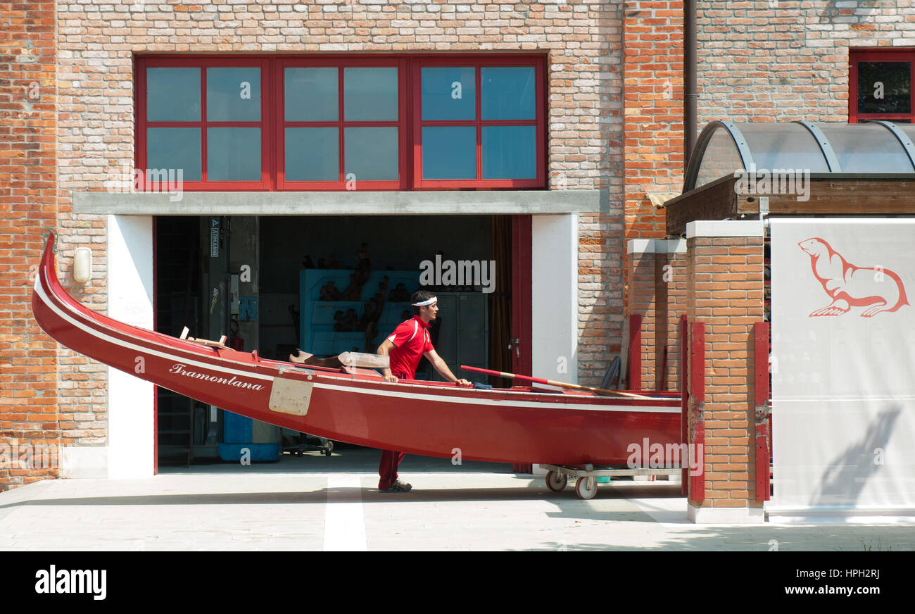 VENICE, ITALY: A rower puts his boat in the warehouse of a remiera in ...