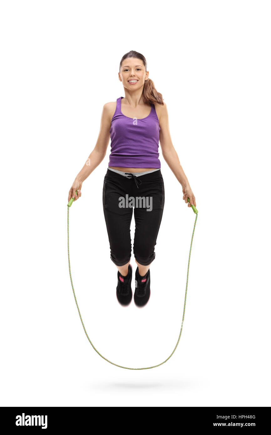 Full length portrait of a female athlete exercising with a skipping ...
