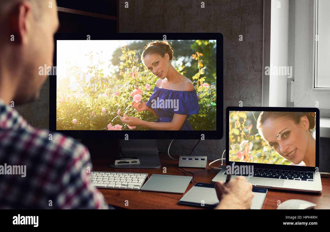 Man editing a photo on his computer. Rear view Stock Photo - Alamy