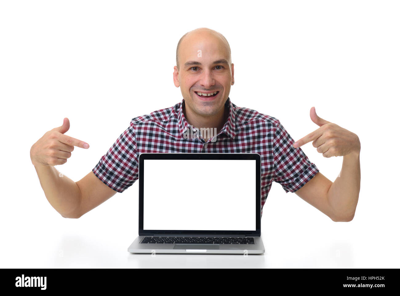bald man sitting at desk and pointing on laptop with blank screen for ...
