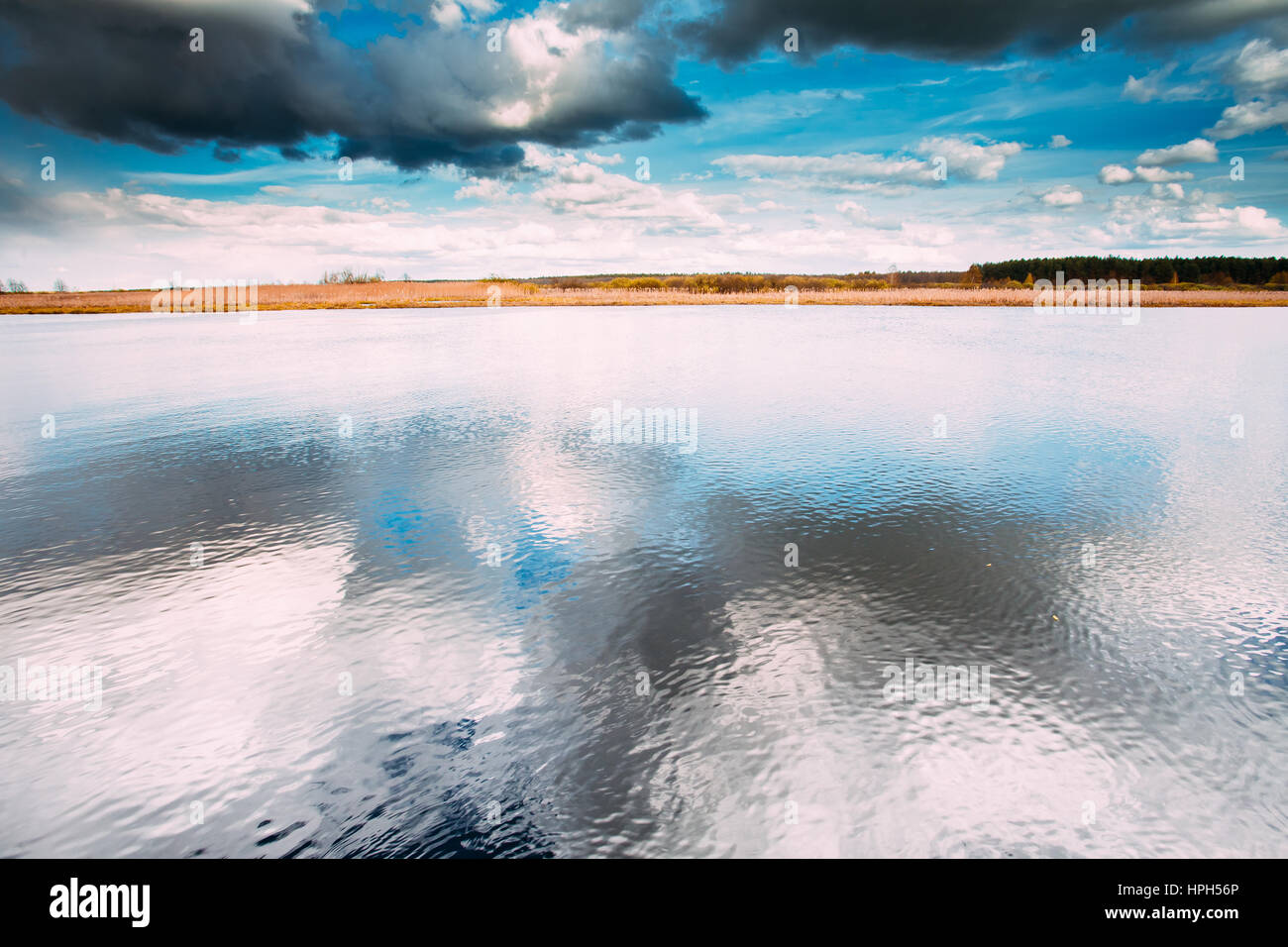 River Or Lake Landscape With Reflections Of Cloudy Sky In Water. Ripple ...