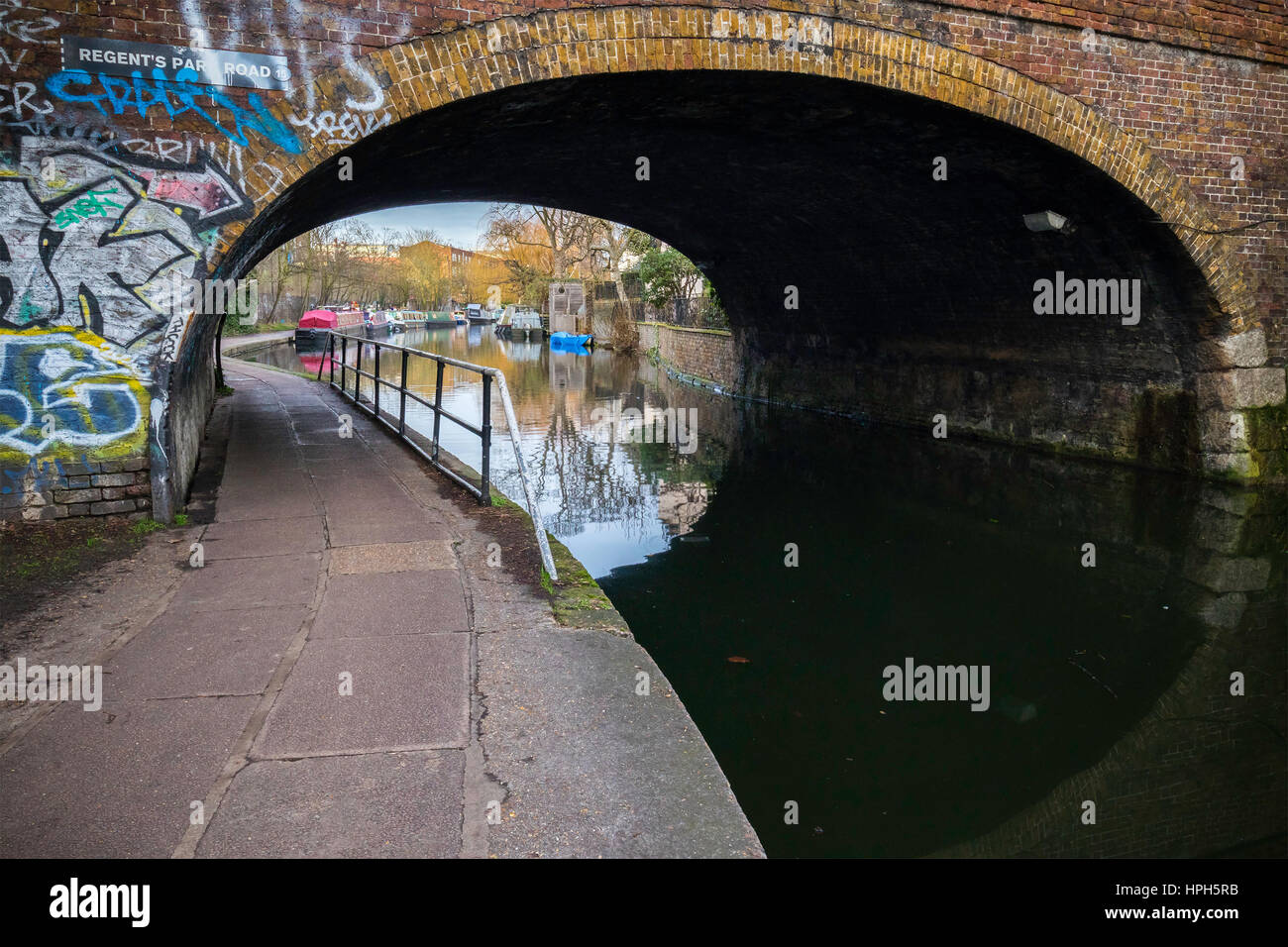 A british river canal with a bridge and house boats in the banks Stock ...