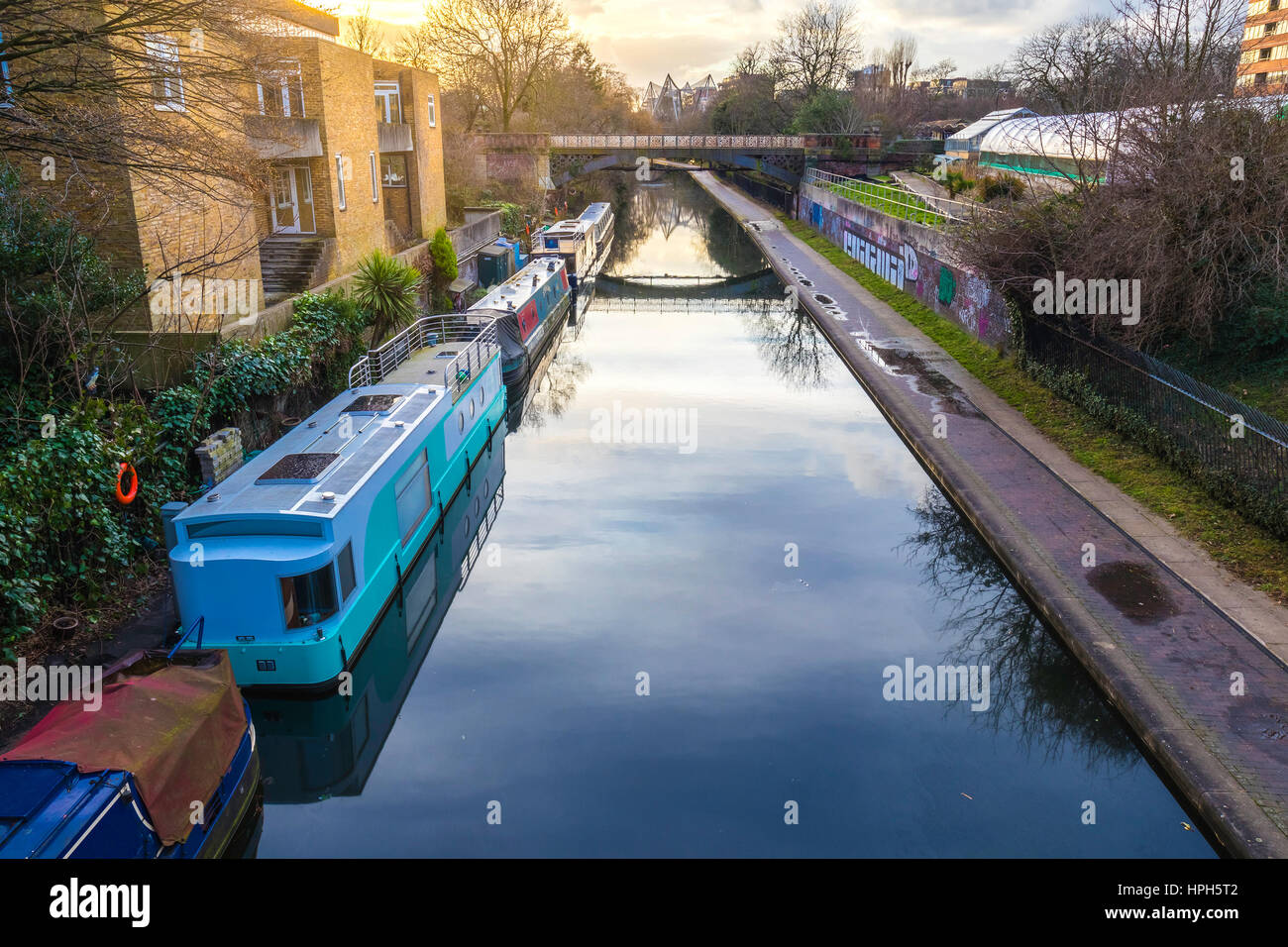 A british river canal with a bridge and house boats in the banks Stock ...