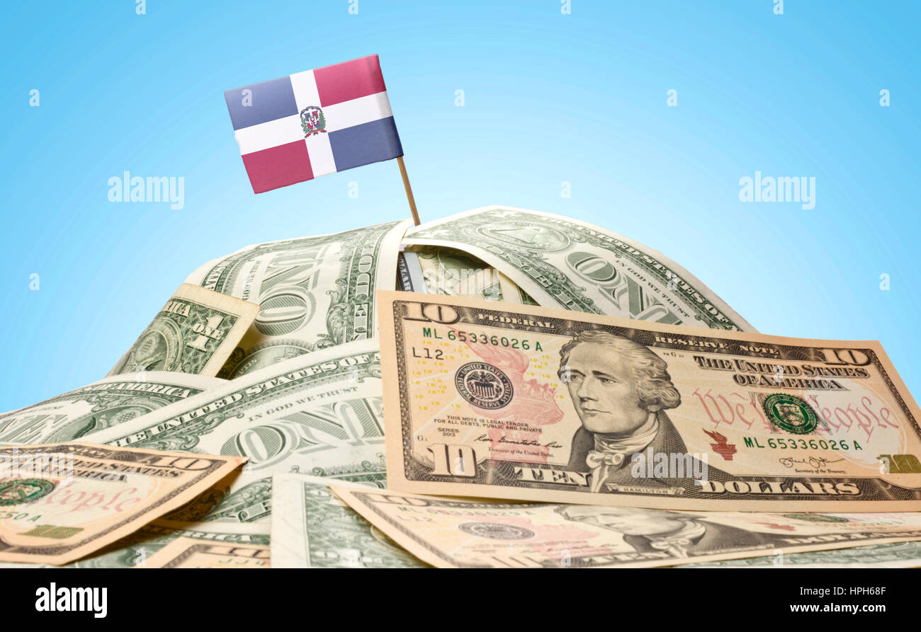 The National Flag Of Dominican Republic Sticking In A Pile Of American Dollars series Stock the-national-flag-of-dominican-republic-sticking-in-a-pile-of-american-dollars-series-stock