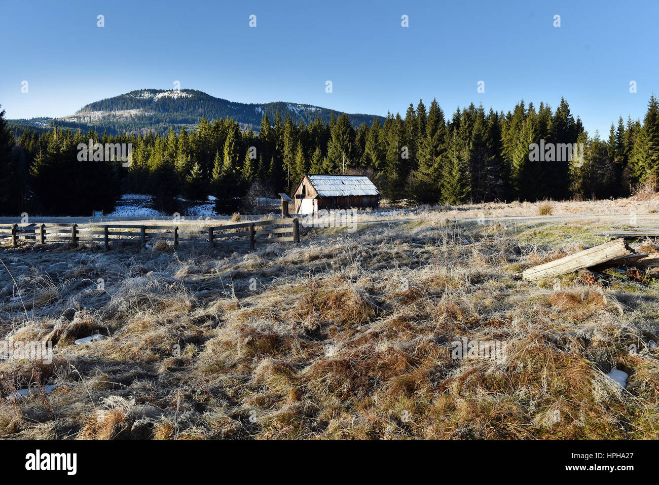 Wooden cottage in the mountains in a cold winter morning Stock Photo ...