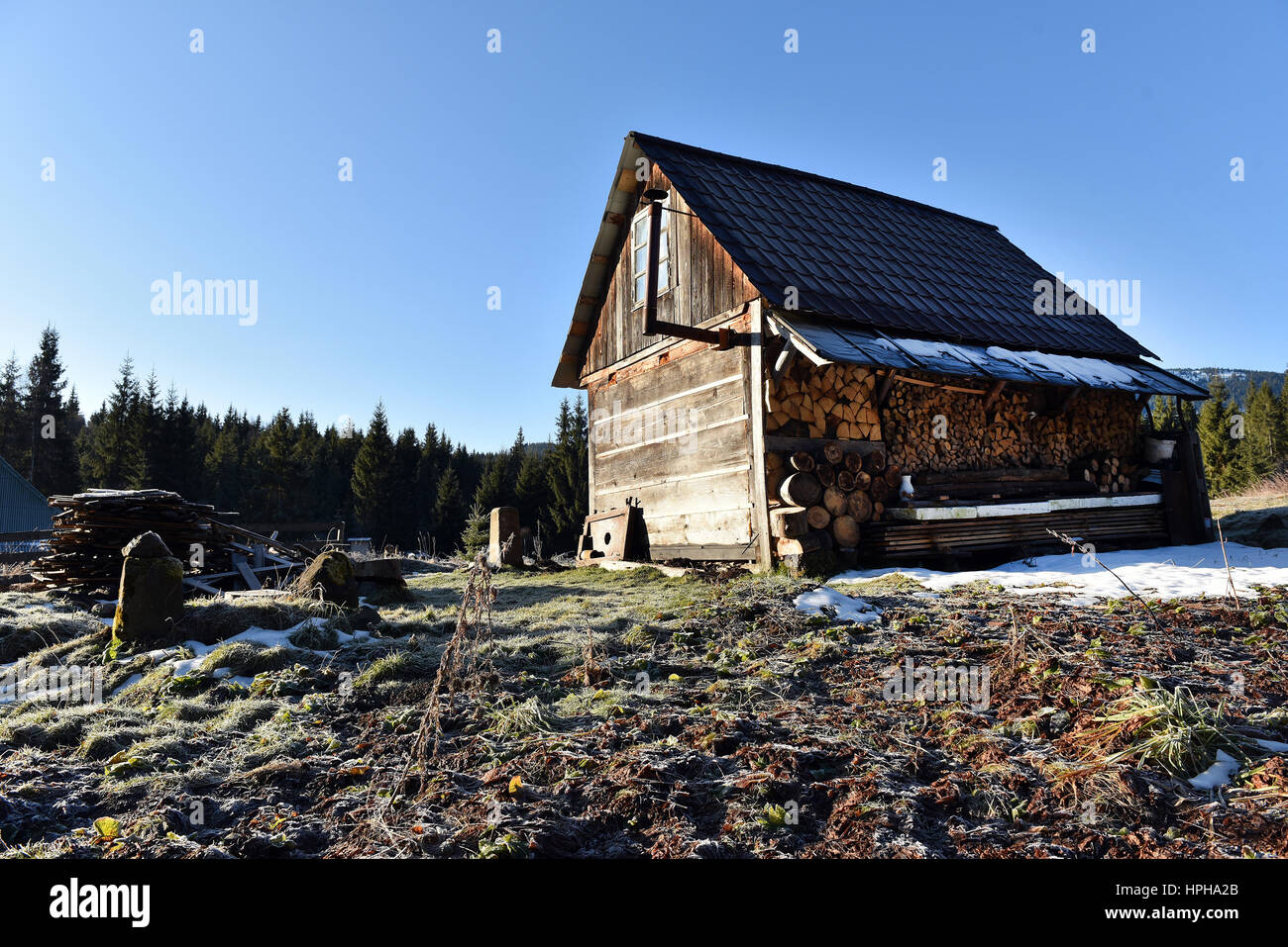 Wooden cottage in the mountains in a cold winter morning Stock Photo ...