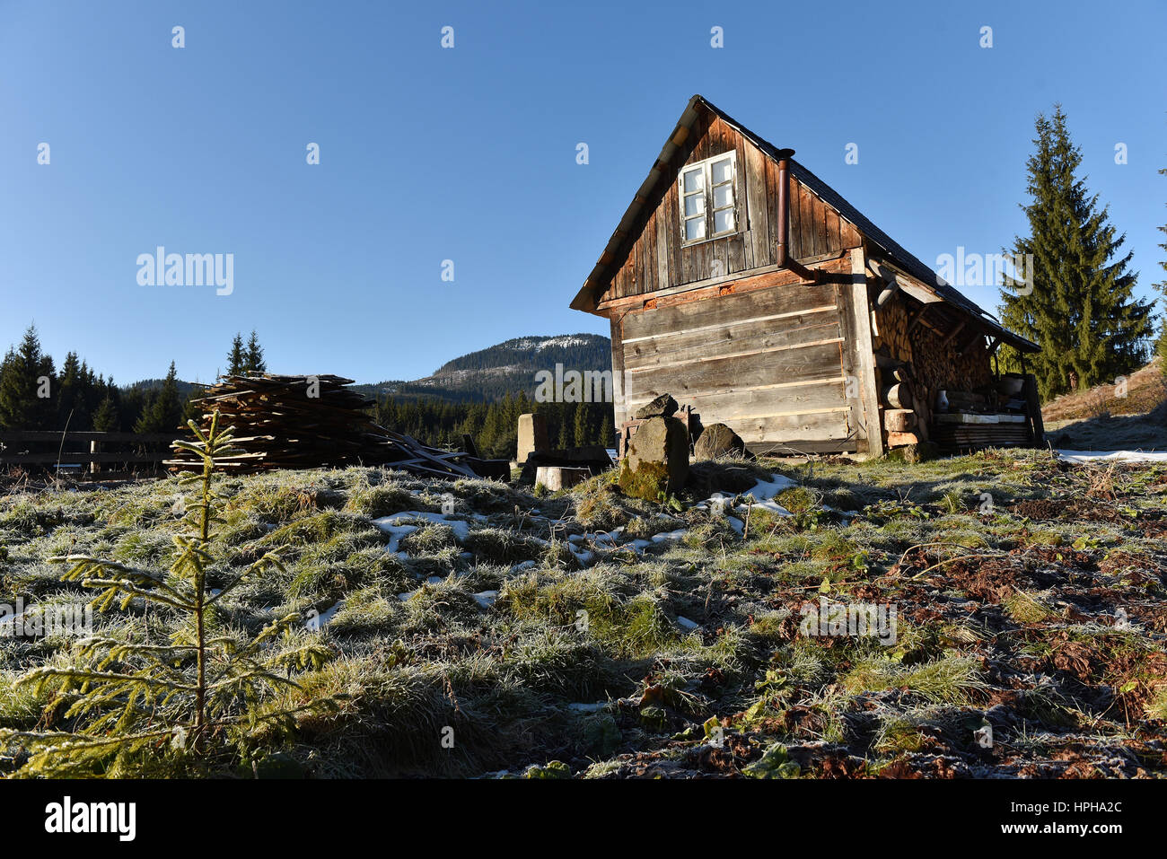 Wooden cottage in the mountains in a cold winter morning Stock Photo ...