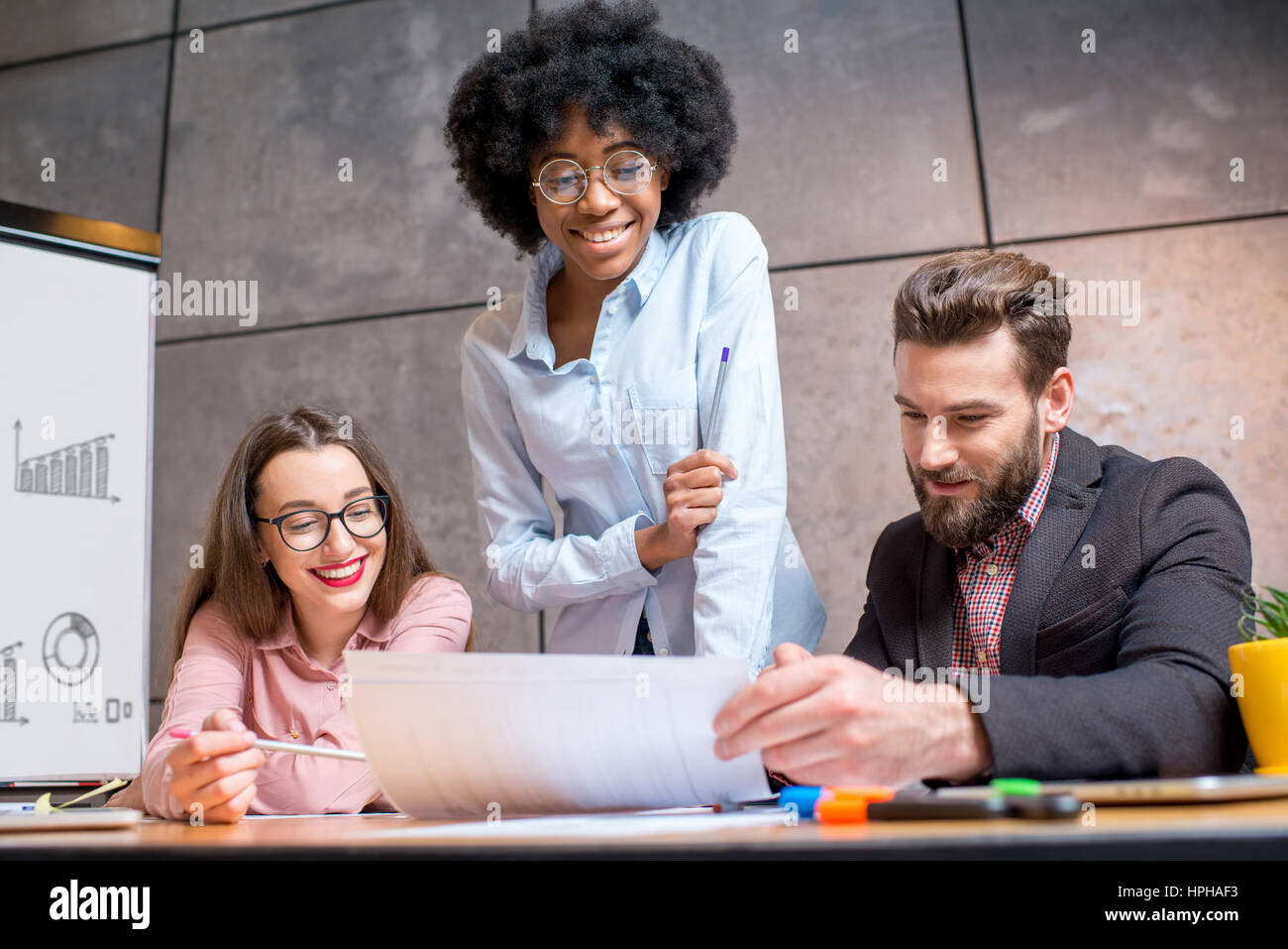 Coworkers working together indoors Stock Photo - Alamy