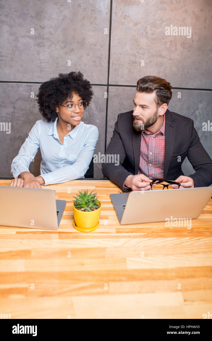 Coworkers working indoors Stock Photo - Alamy