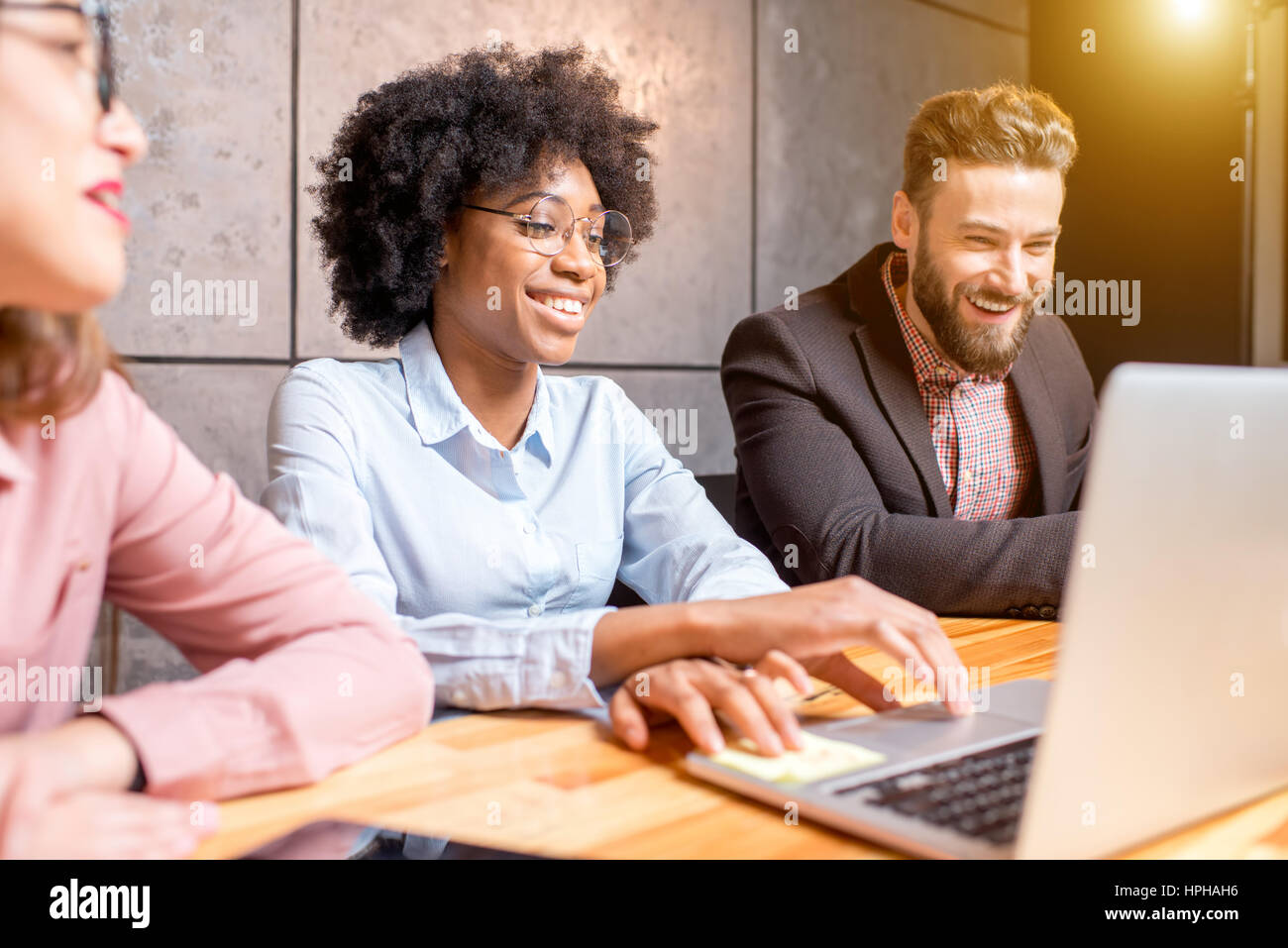 Positive multi ethnic team working hi-res stock photography and images ...