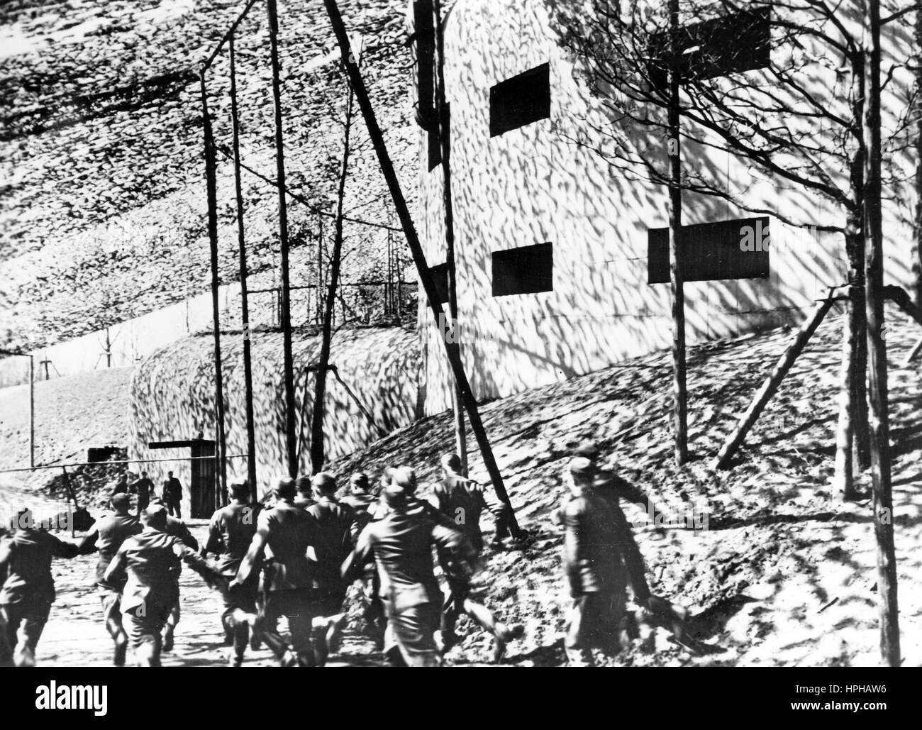 The Nazi propaganda image shows German Wehrmacht soldiers carrying out ...