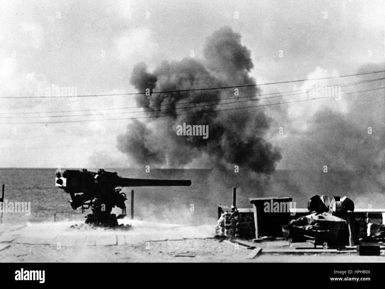 The Nazi propaganda image shows a German Wehrmacht anti-ship gun at a ...