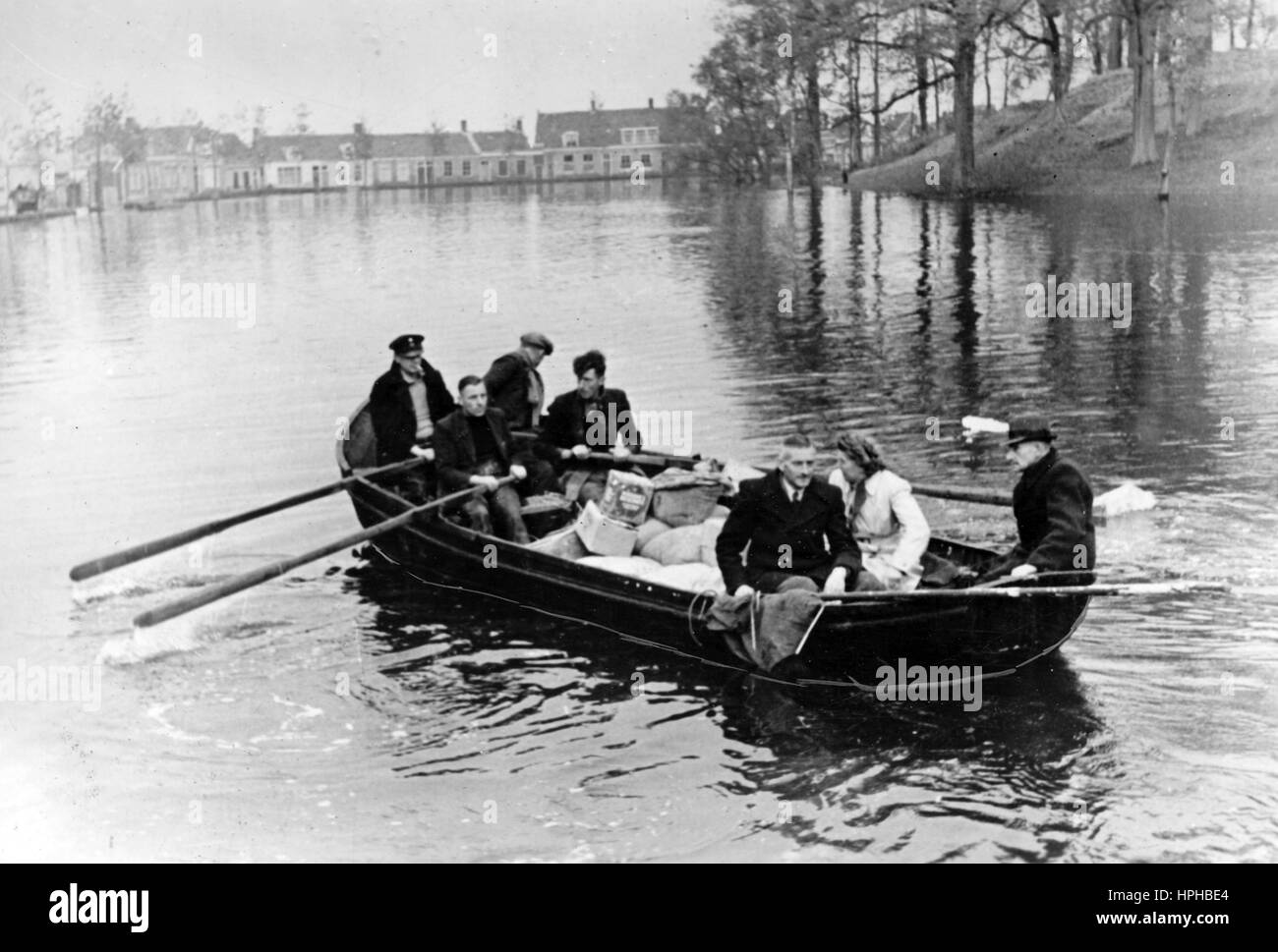 The Nazi propaganda image shows locals in a boat crossing a flooded ...
