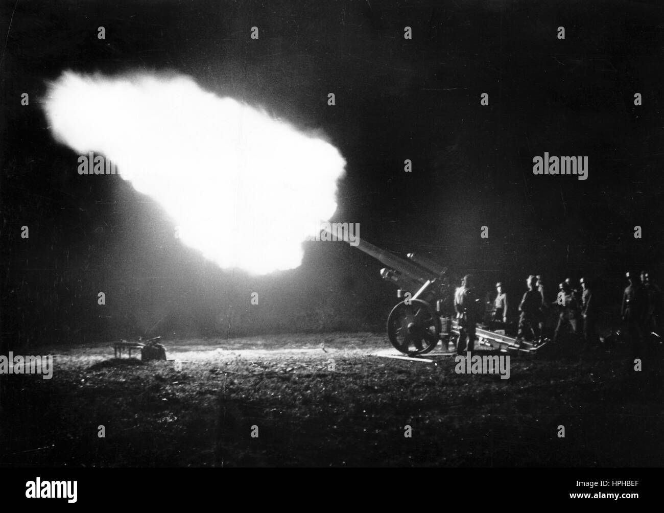 The Nazi propaganda image shows German Wehrmacht soldiers firing a gun ...