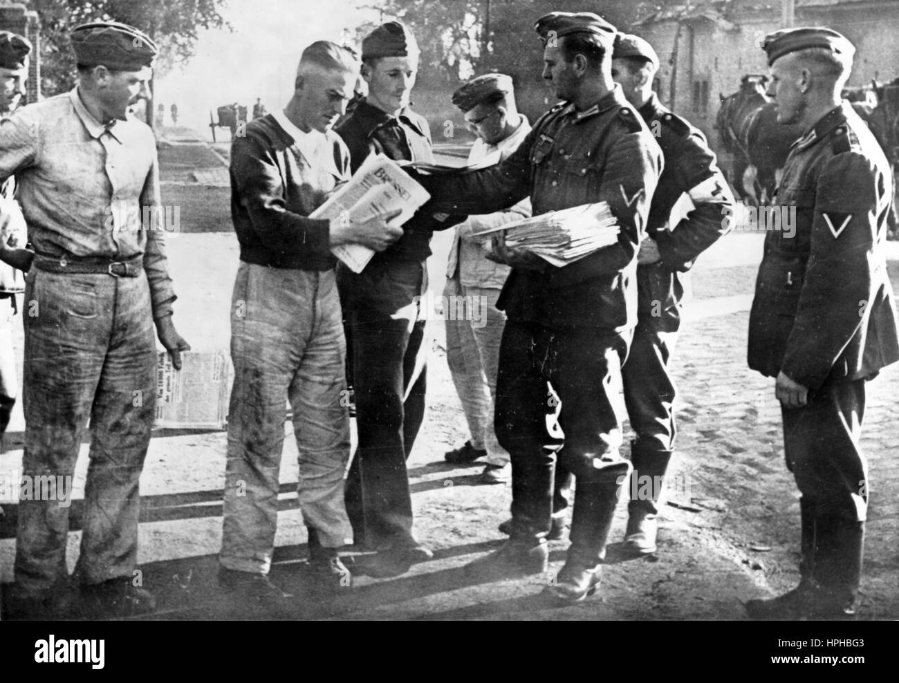 The Nazi propaganda image shows German Wehrmacht soldiers with a German ...