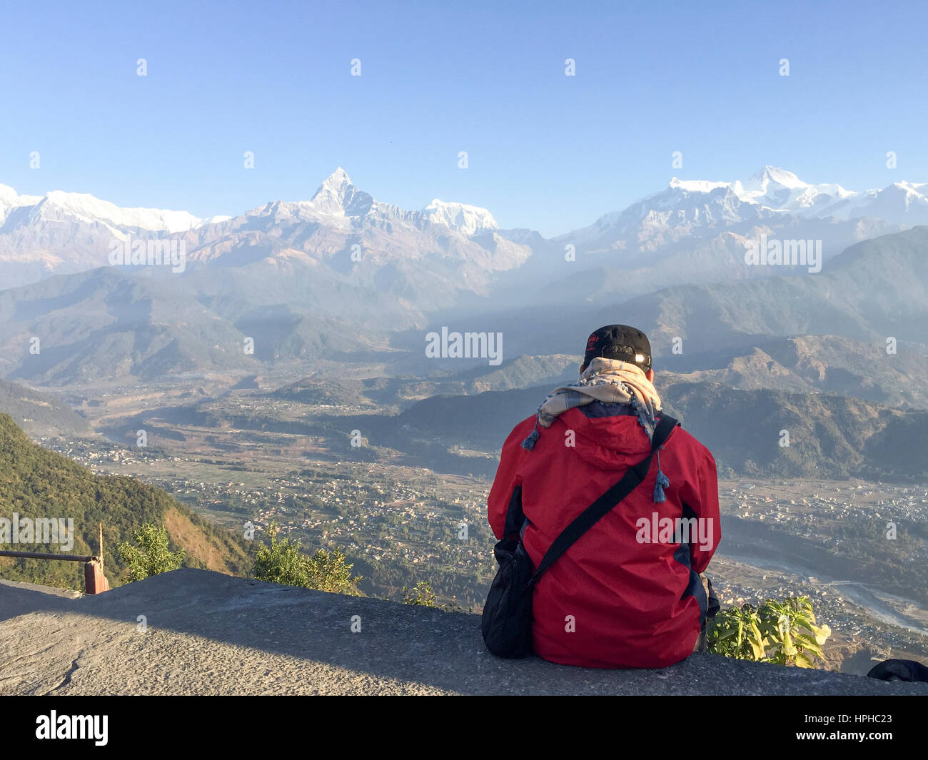 Tourist facing the Annapurna Mountain Range after sunrise at Sarangkot ...