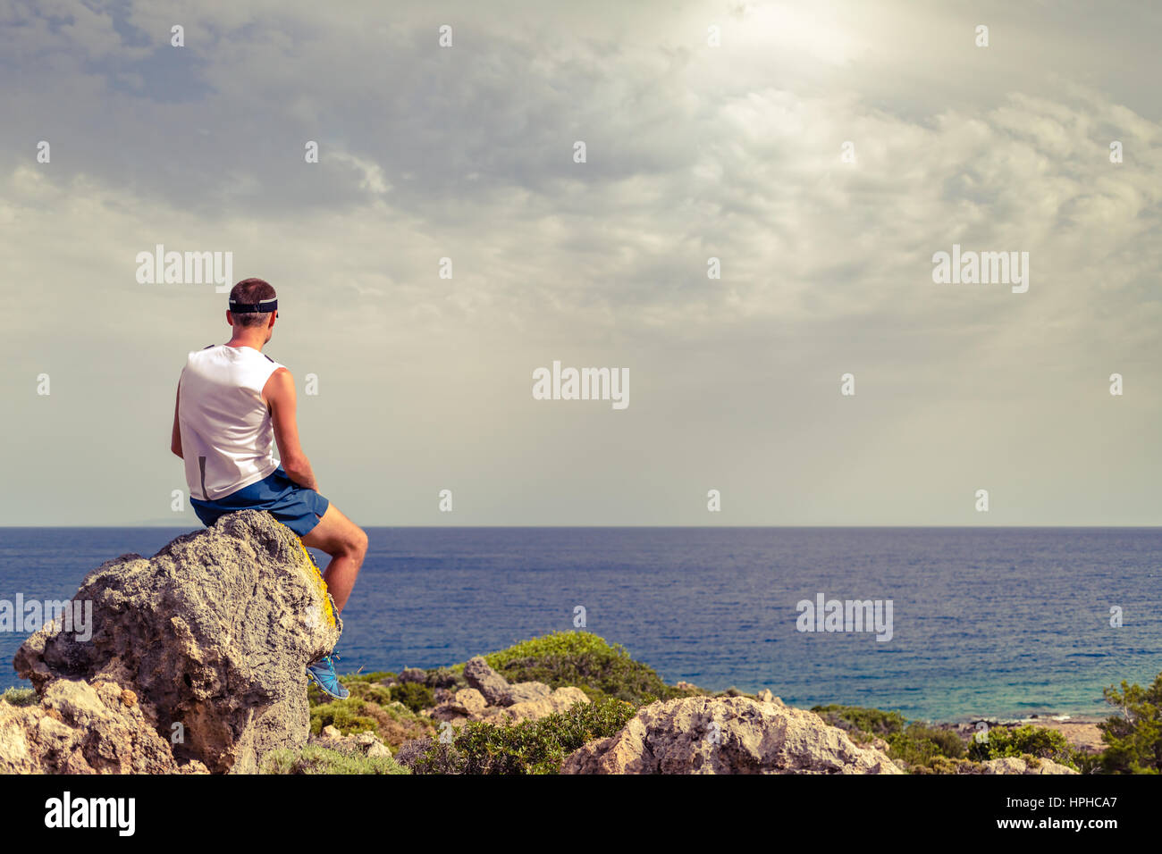 Trail runner looking inspirational ocean landscape when relaxing on ...