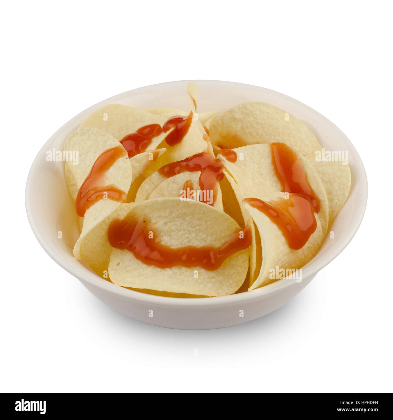 side view of round potato chips in a white round shaped ceramic bowl ...