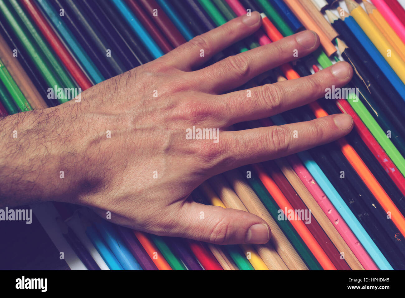 Horizontal top view close up of a male Caucasian hand touching a set of ...