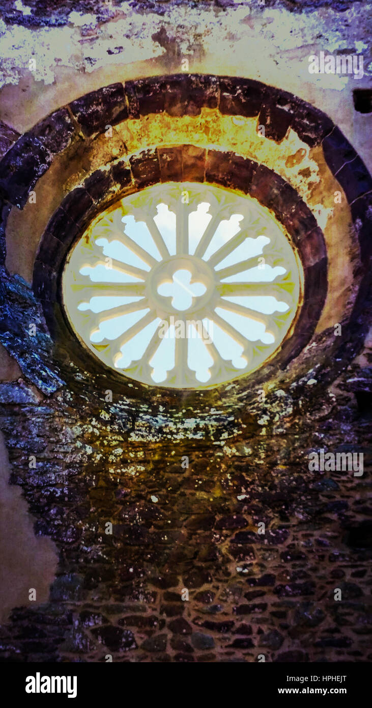 An architeuctural window made of stone. It contains symmetrical details ...