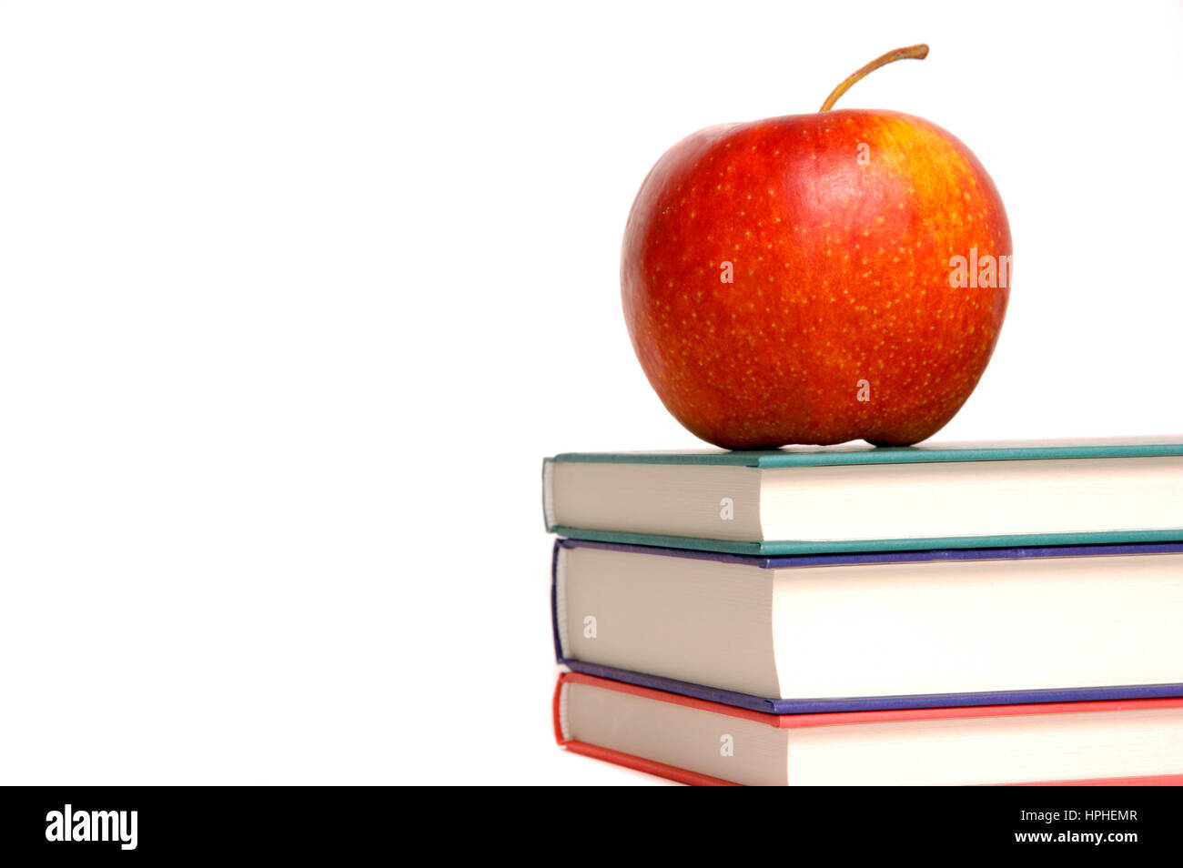 a red apple on top of a pile of books Stock Photo - Alamy