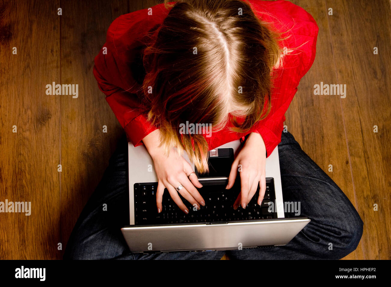 a blond teenager girl typing on her laptop Stock Photo - Alamy