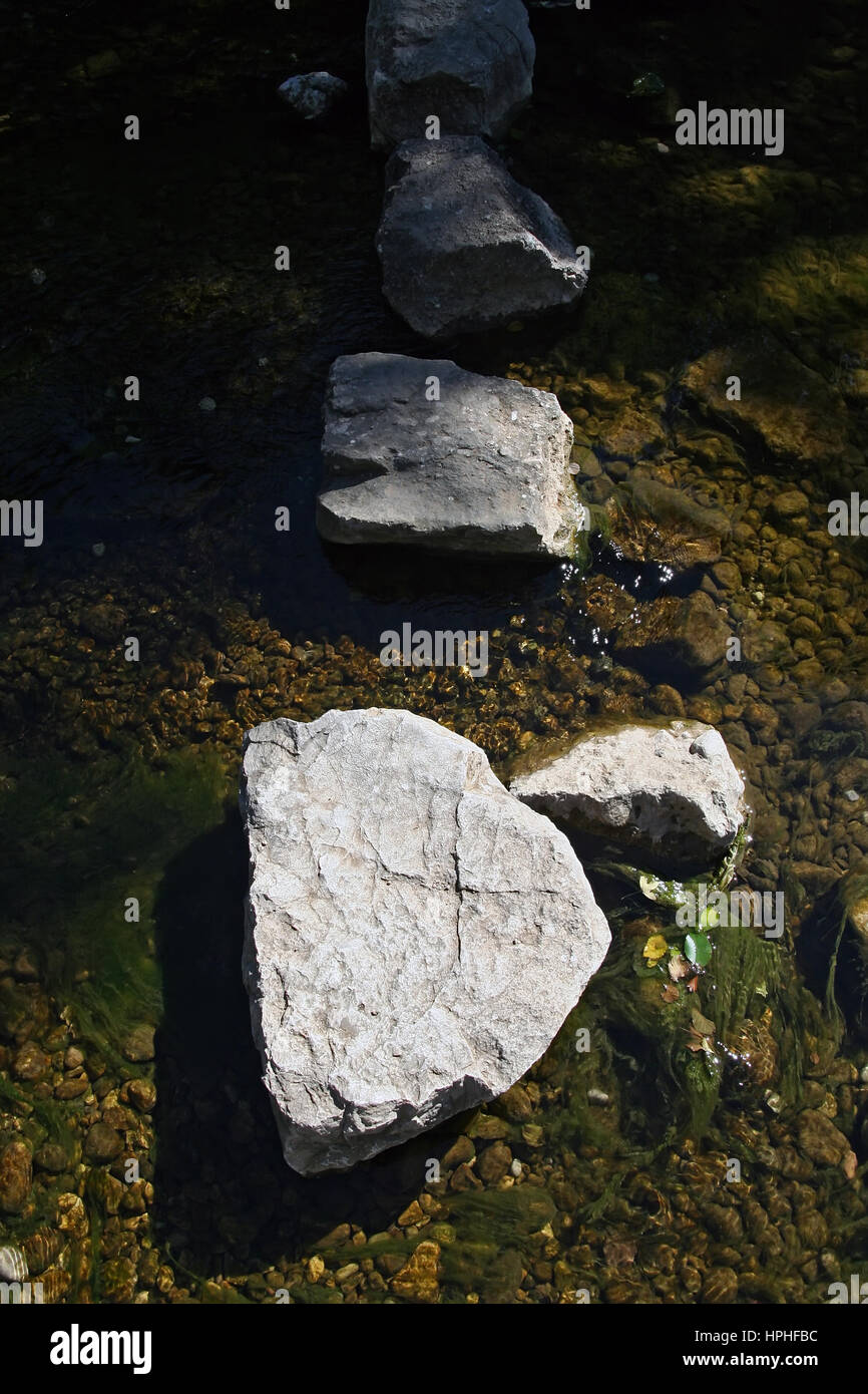 Stone path on a small river Stock Photo - Alamy