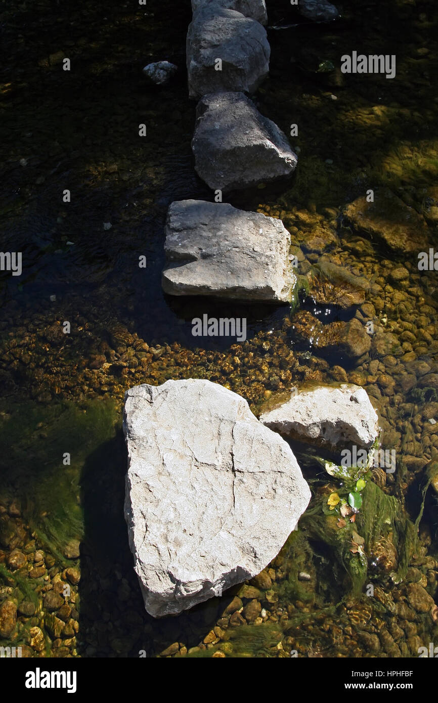 Stone path on a small river Stock Photo - Alamy
