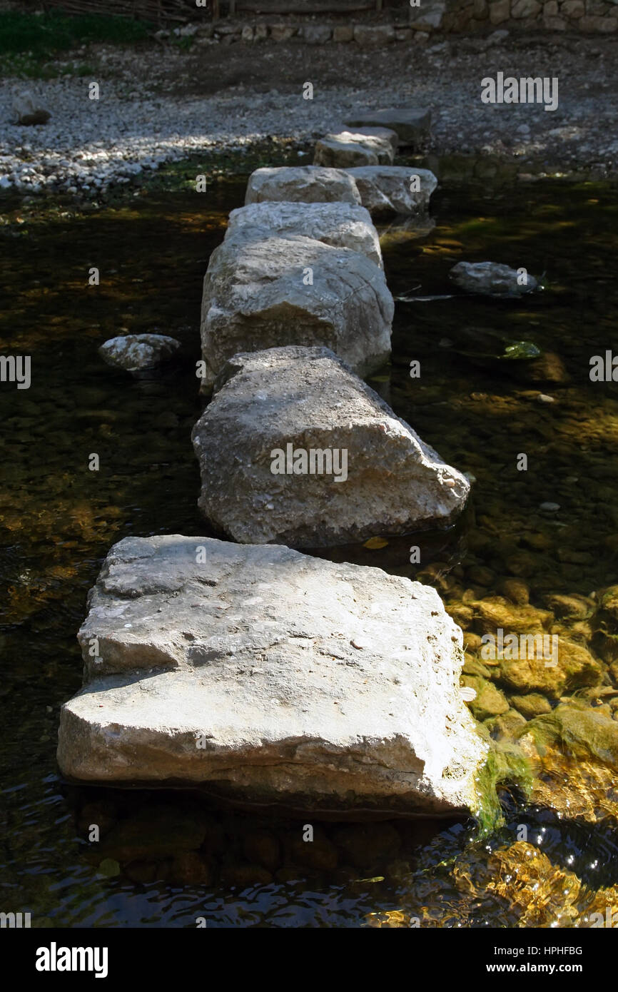 Stone path on a small river Stock Photo - Alamy