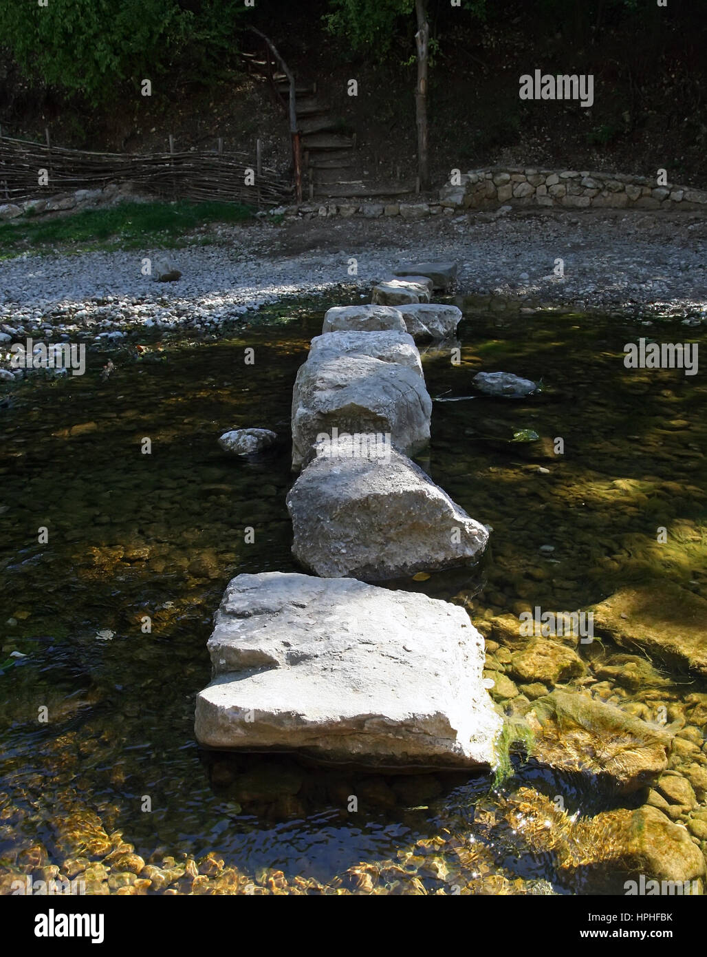 Stone path on a small river Stock Photo - Alamy
