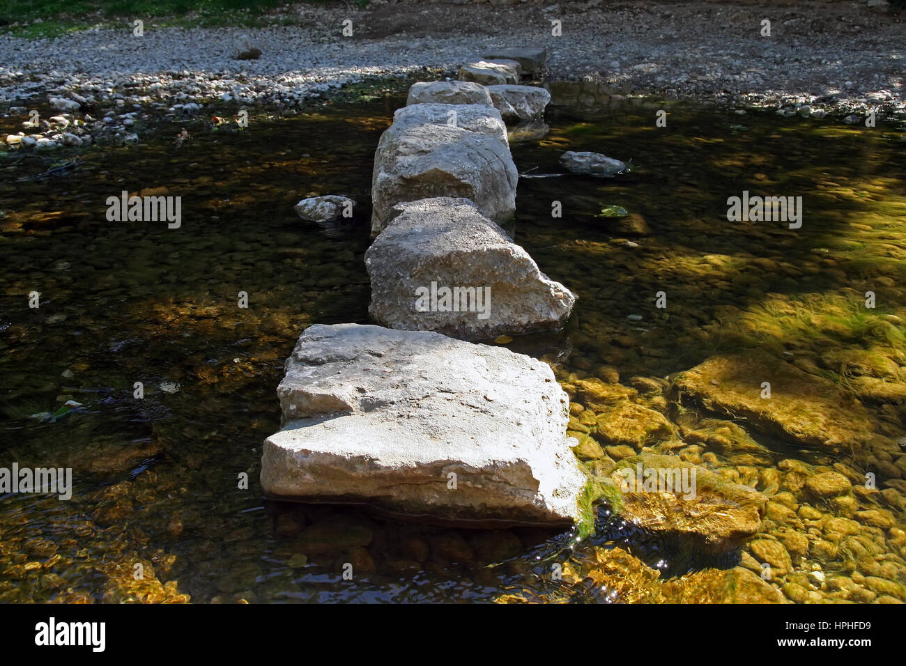 Stone path on a small river Stock Photo - Alamy