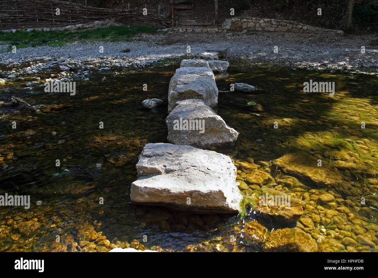 Stone path on a small river Stock Photo - Alamy