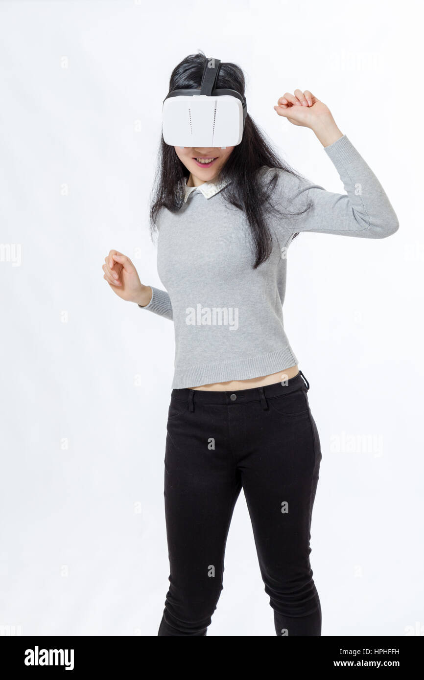 Teenage girl wearing 3D VR goggles, dancing and smiling Stock Photo - Alamy