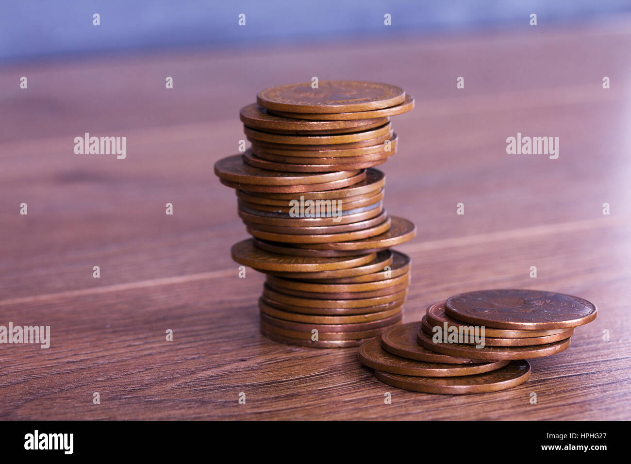 Stack of old penny coins on a wooden surface Stock Photo - Alamy