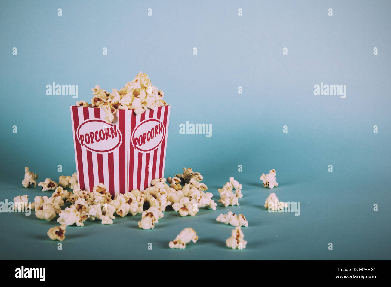 Bucket of popcorn against a blue background Vintage Retro Filter Stock ...