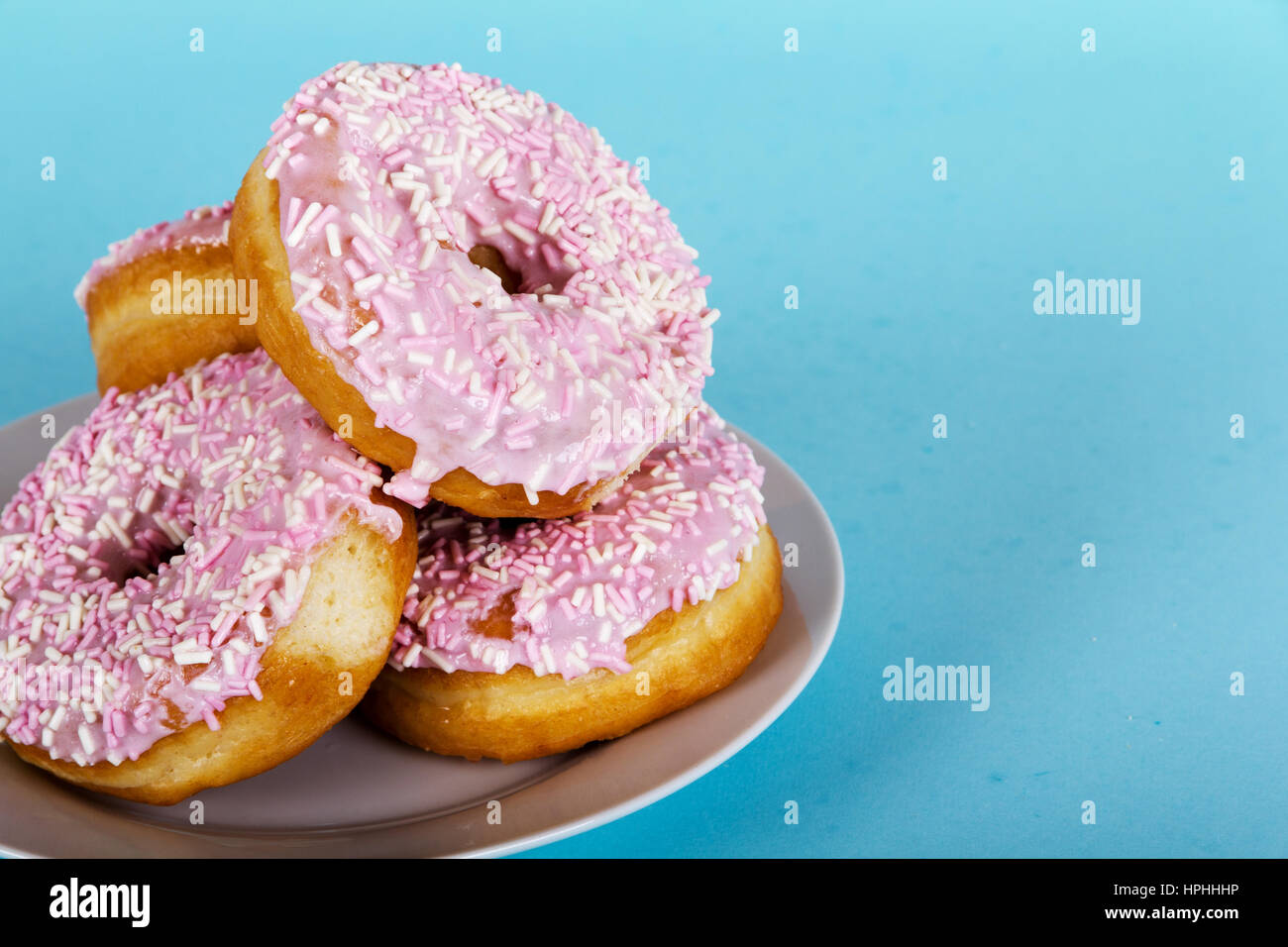 Iced doughnut on a light coloured blue background Stock Photo - Alamy