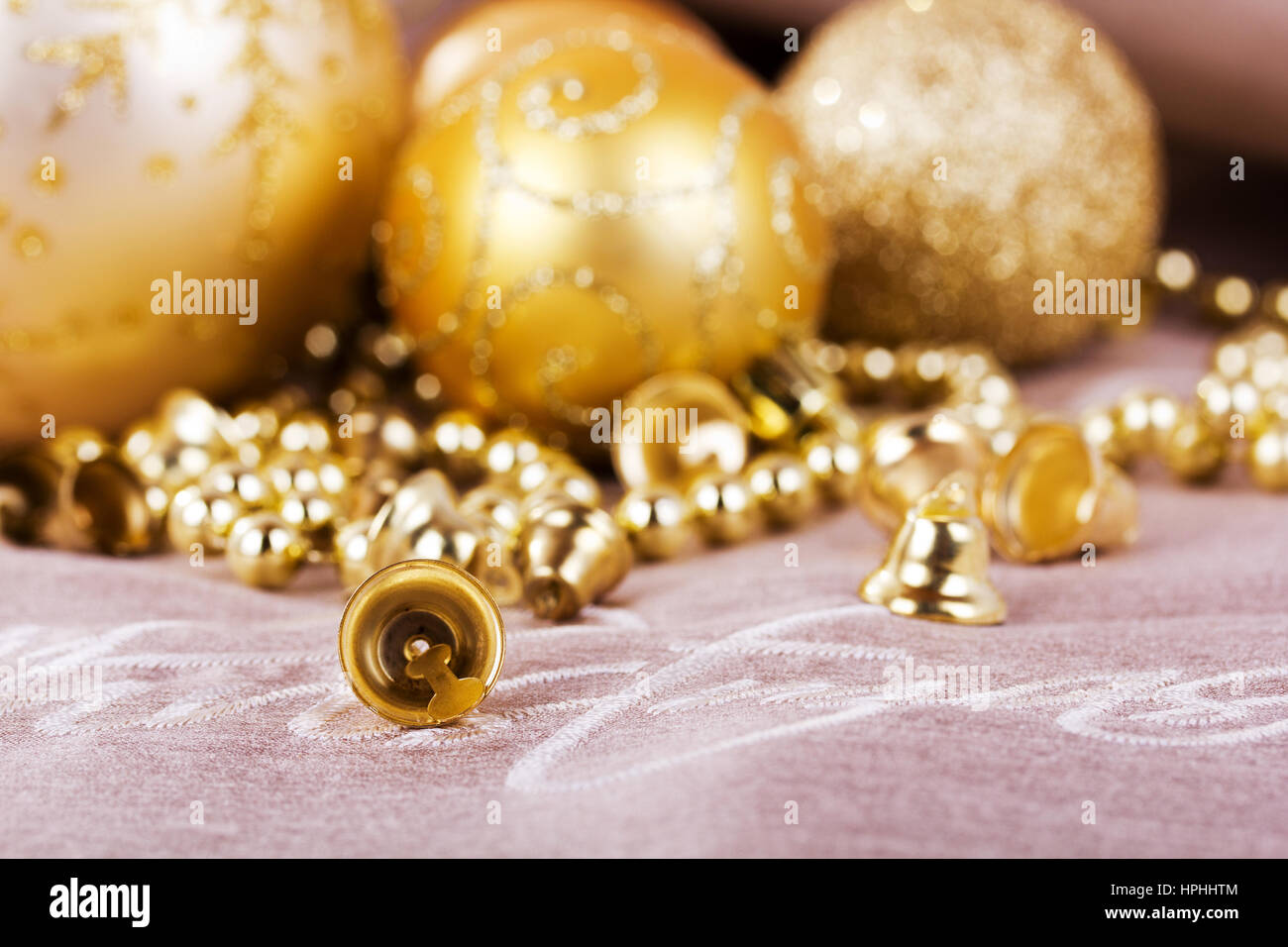 Festive gold Christmas decorations on a fabric background Stock Photo ...